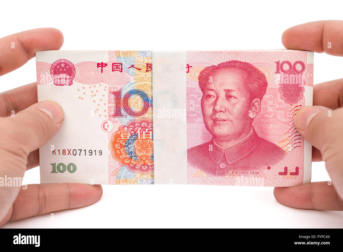 hand holding stacks of 100 RMB paper currency on white with clipping ...