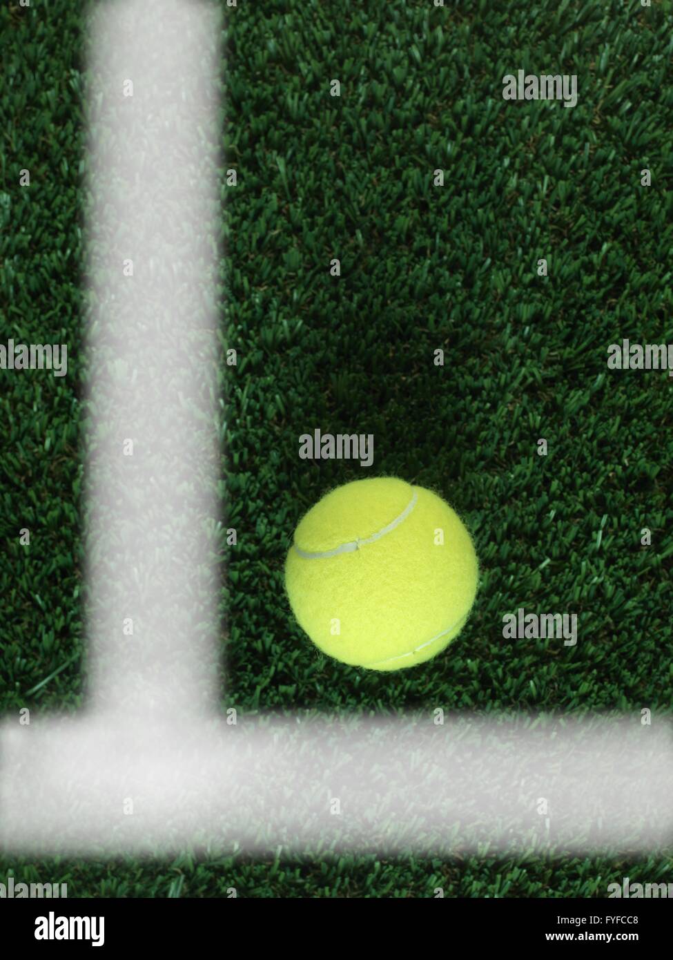Sporting tennis balls on artificial green grass Stock Photo - Alamy