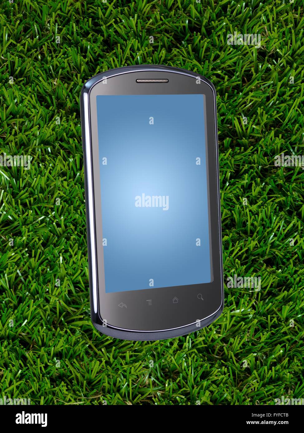 A mobile phone isolated against a green grass Stock Photo - Alamy