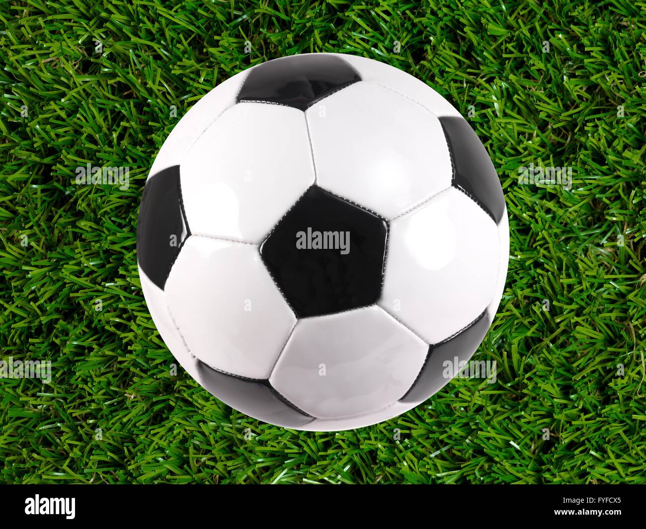 Black and white soccer balls isolated on artificial grass Stock Photo ...
