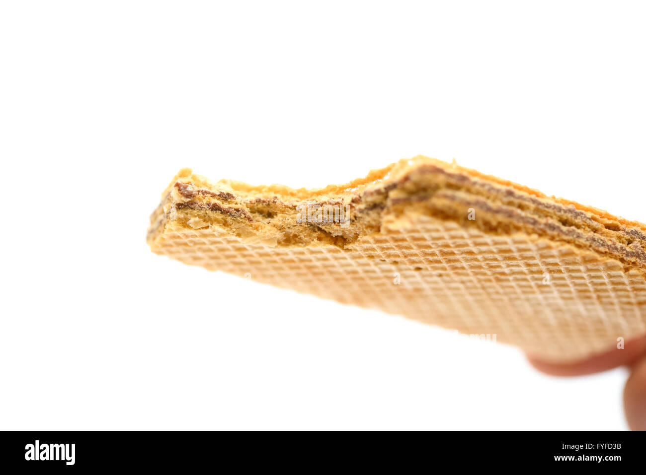 holding a wafer block with a bite on a white background Stock Photo - Alamy
