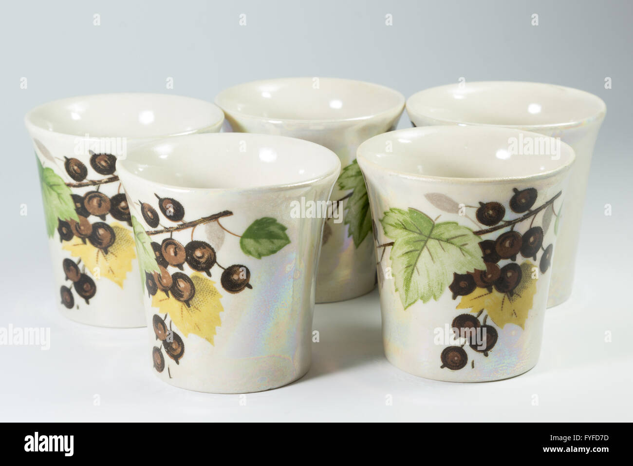 five painted porcelain shot glasses on a white background Stock Photo ...
