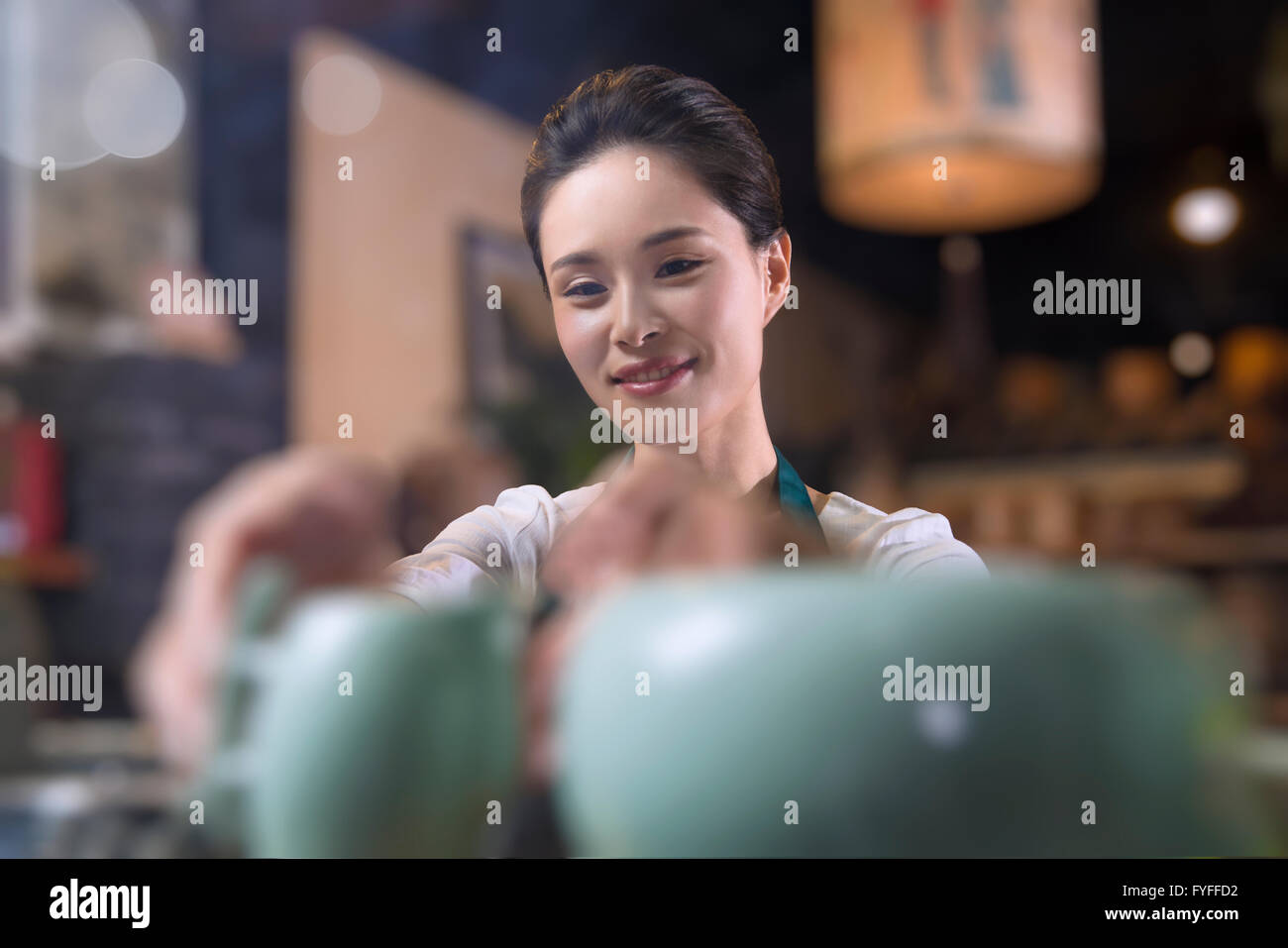 Antique shop owner arranging window display Stock Photo - Alamy