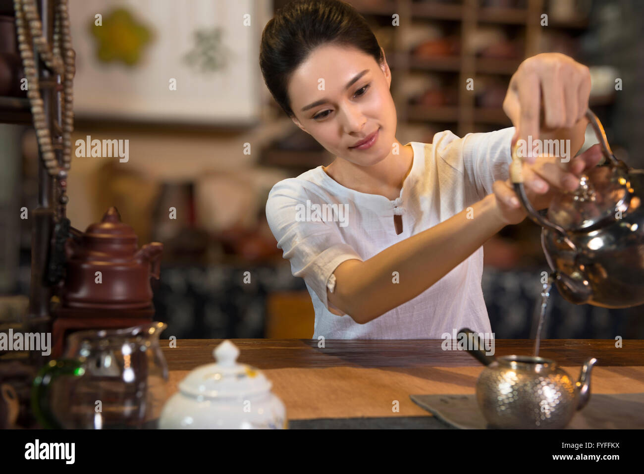 Tea house owner making tea Stock Photo - Alamy