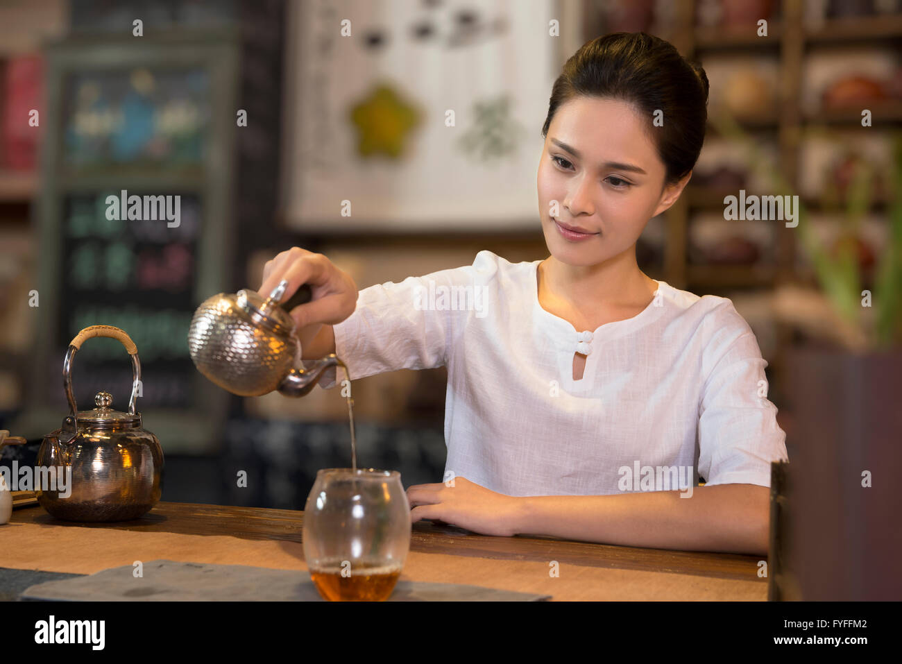 Tea house owner making tea Stock Photo - Alamy