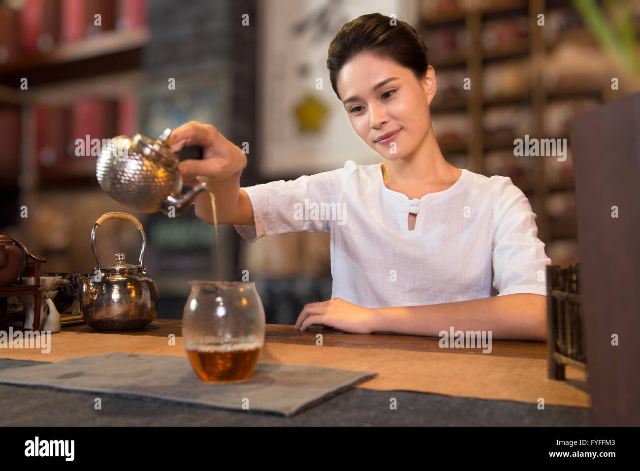 Tea house owner making tea Stock Photo - Alamy