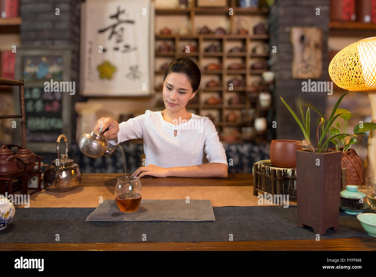 Tea house owner making tea Stock Photo - Alamy