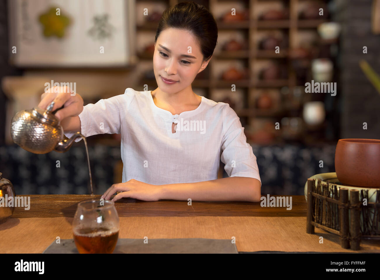 Tea house owner making tea Stock Photo - Alamy
