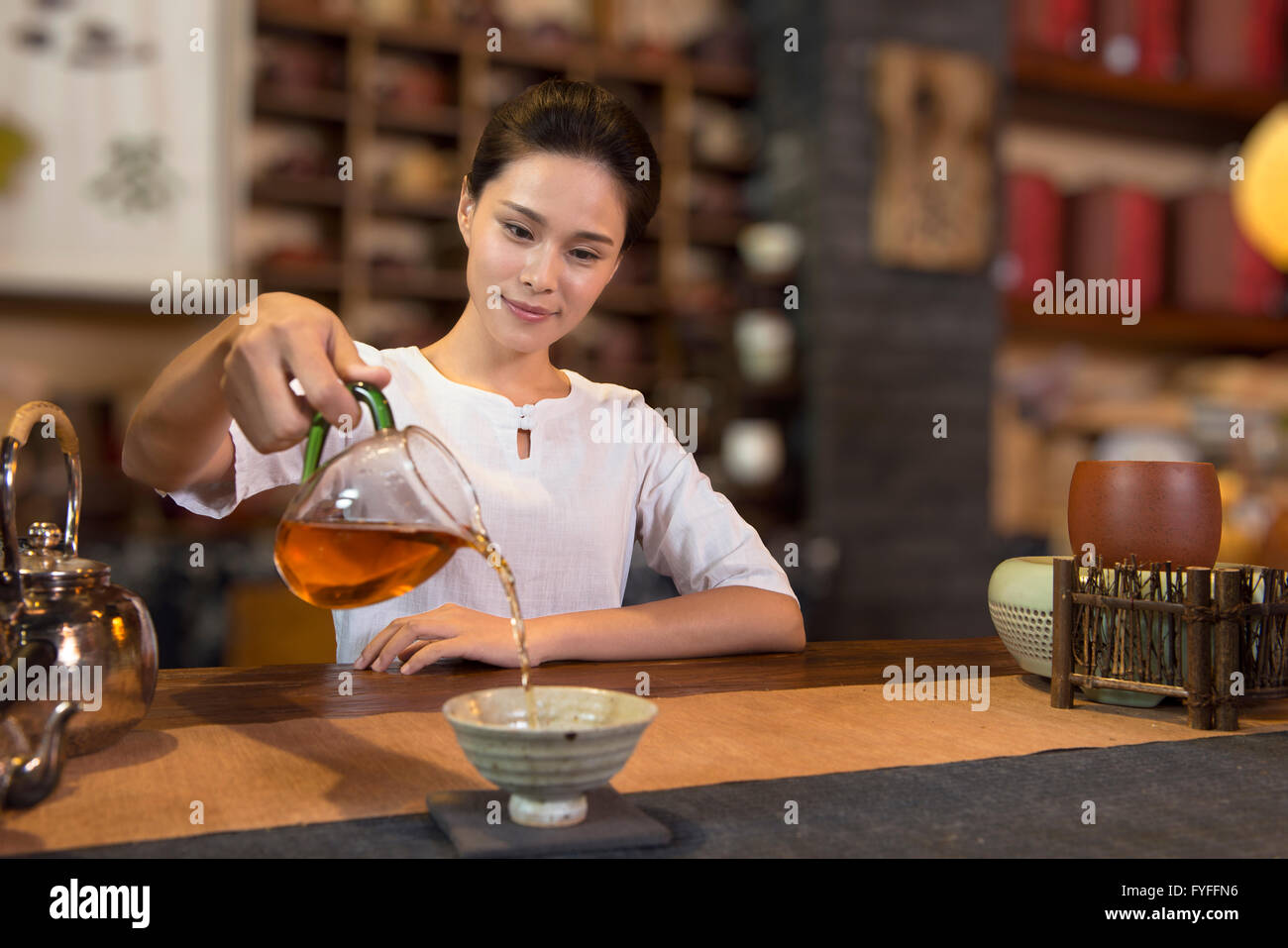 Tea house owner making tea Stock Photo - Alamy