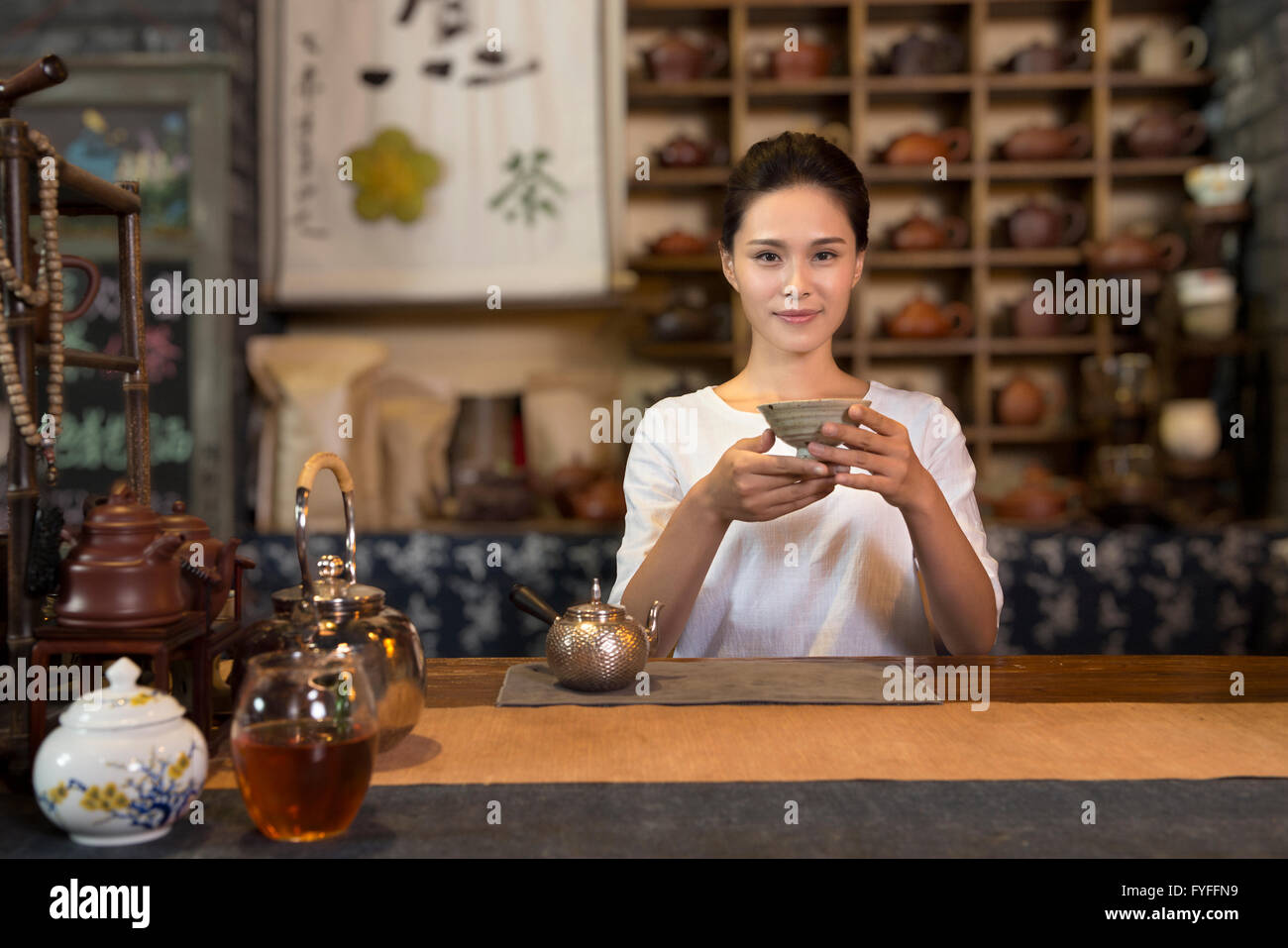 Tea house owner serving tea Stock Photo - Alamy