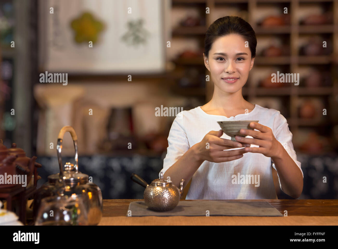 Tea house owner serving tea Stock Photo - Alamy