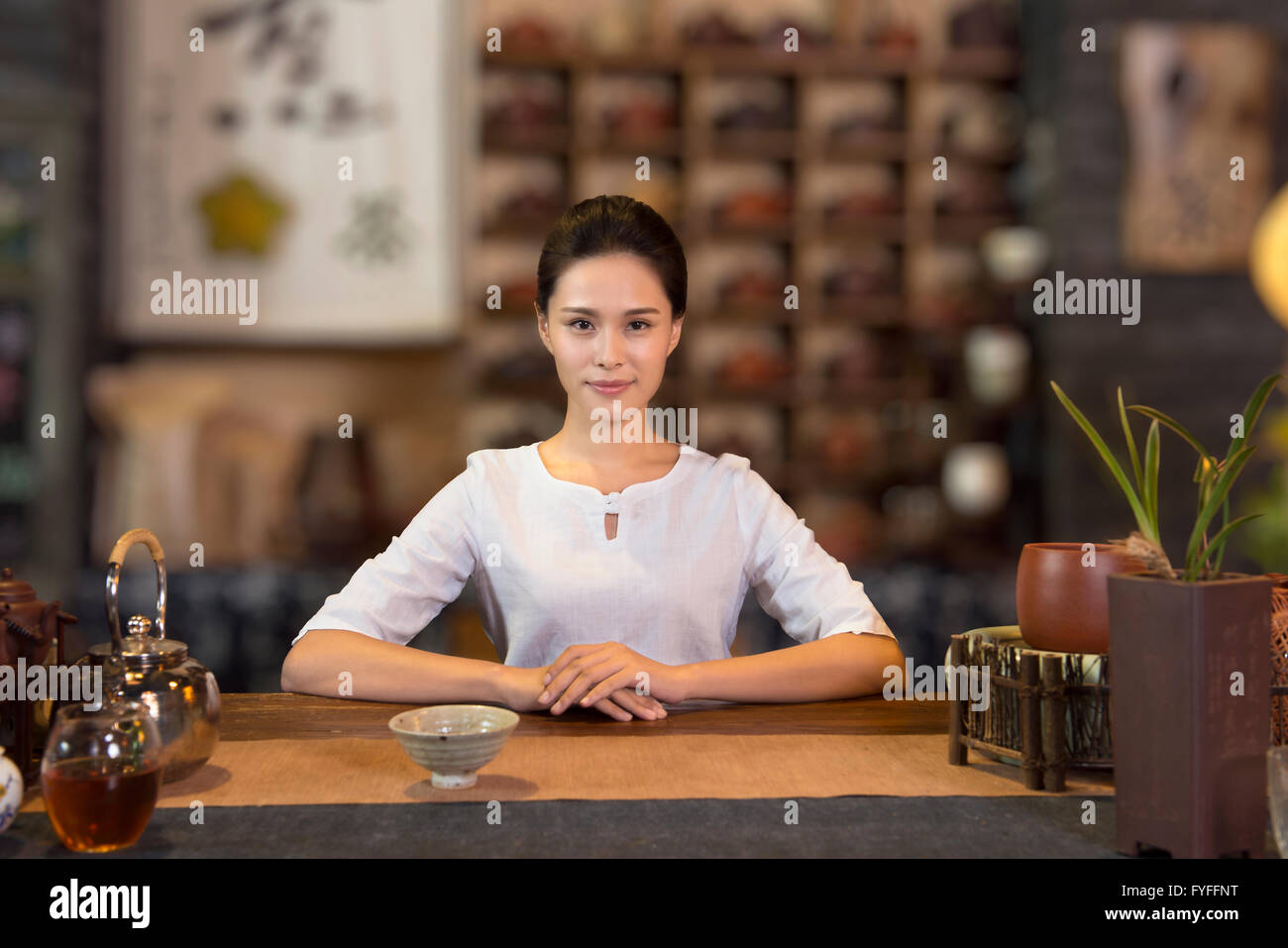 Tea house owner serving tea Stock Photo - Alamy