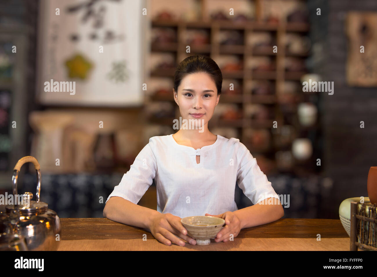 Tea house owner serving tea Stock Photo - Alamy