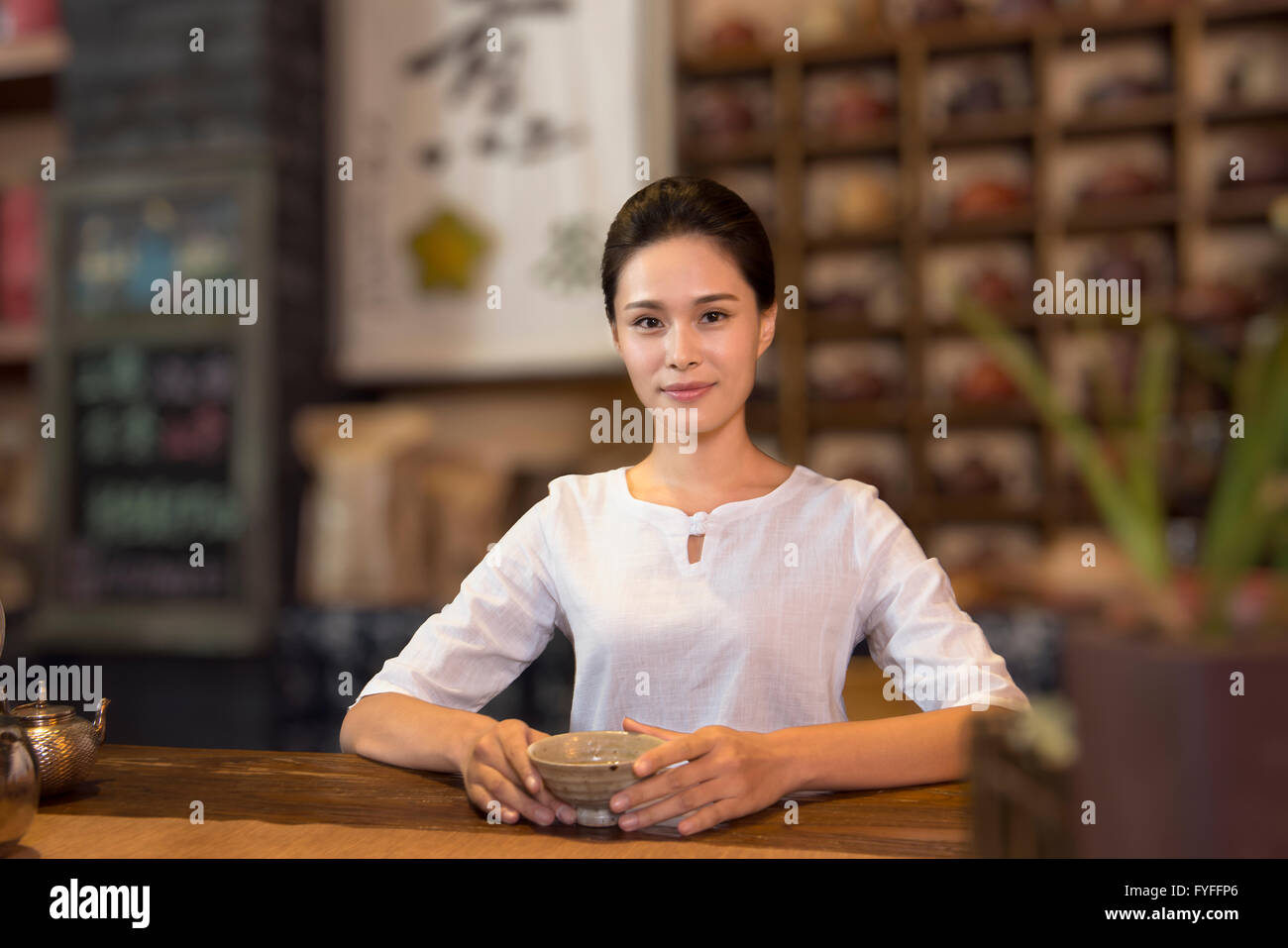 Tea house owner serving tea Stock Photo - Alamy