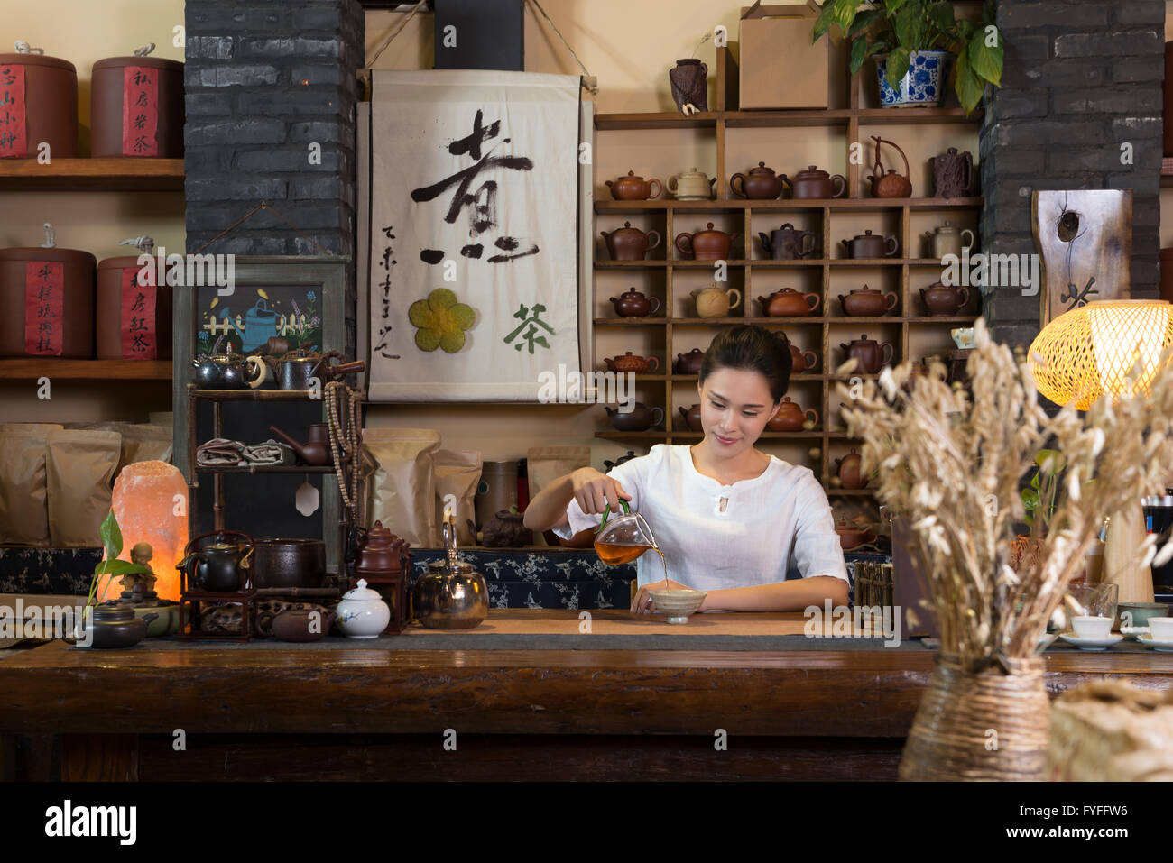 Tea house owner making tea Stock Photo - Alamy