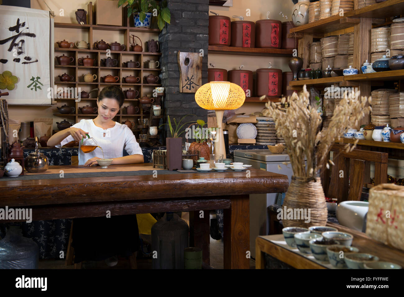 Tea house owner making tea Stock Photo - Alamy