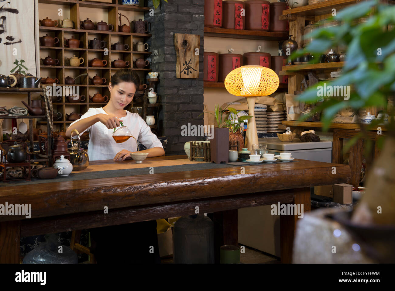 Tea house owner making tea Stock Photo - Alamy