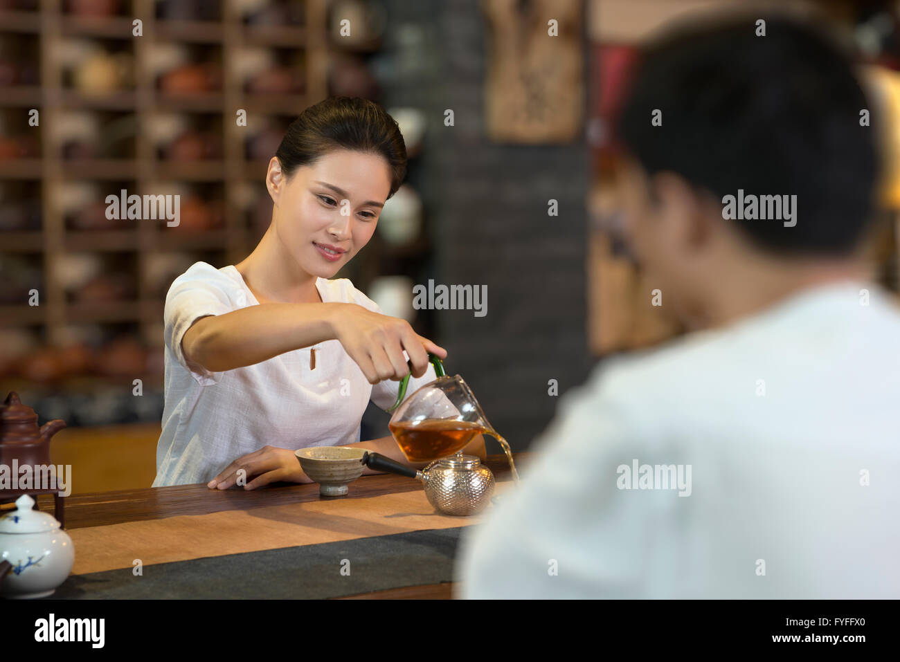 Tea house owner serving tea Stock Photo - Alamy