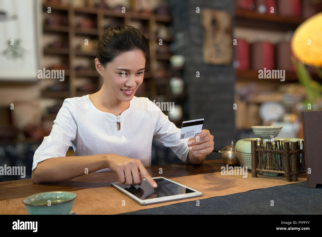 Tea house owner using digital tablet Stock Photo - Alamy