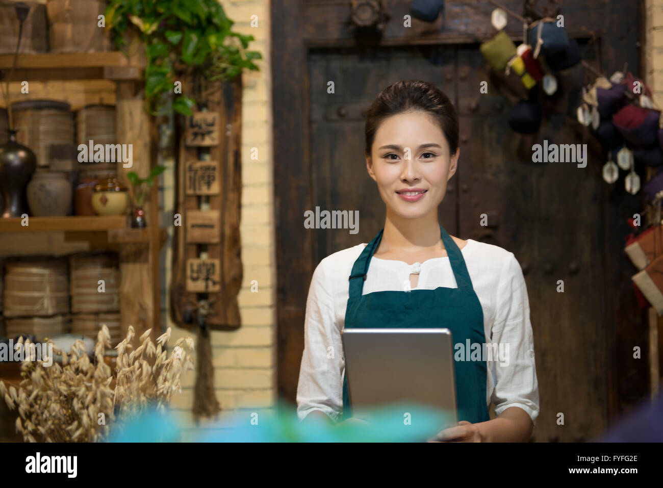 Tea house owner using digital tablet Stock Photo - Alamy