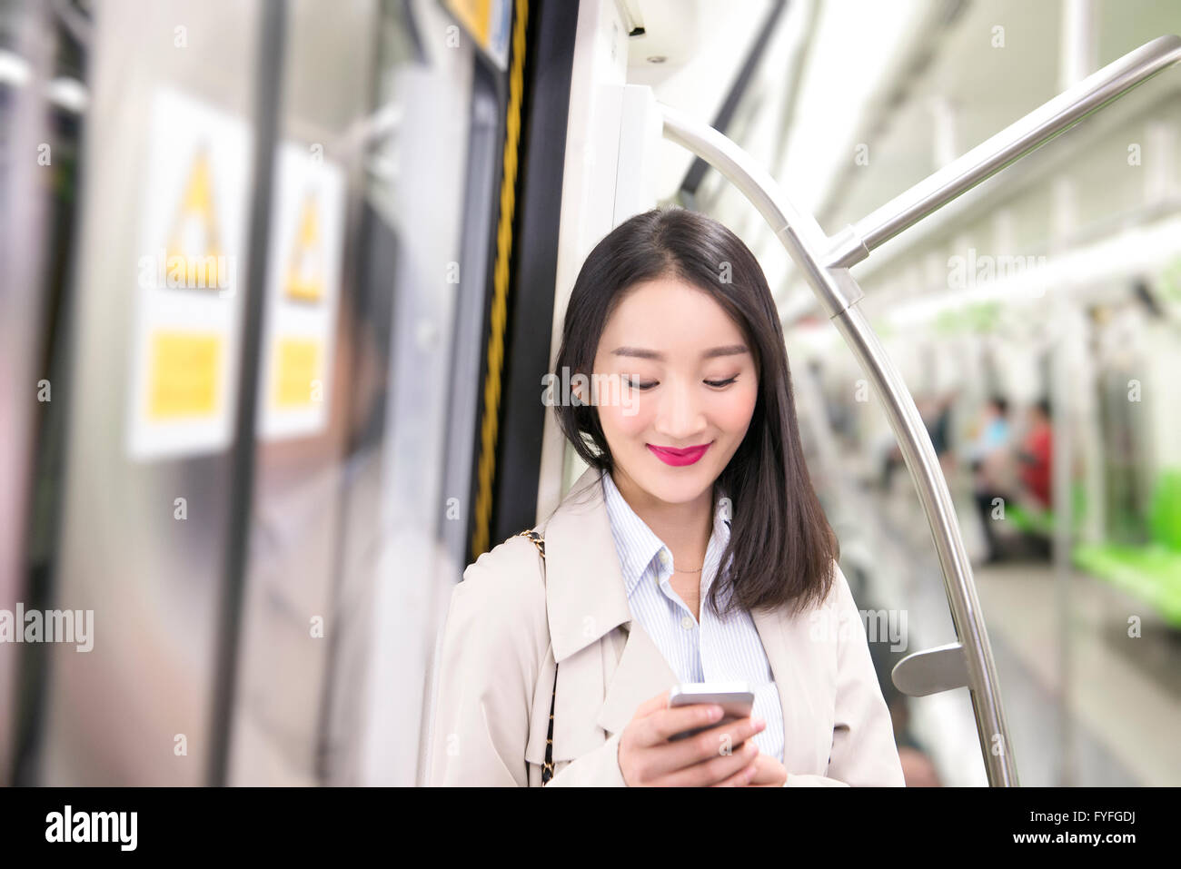 Person in subway train with phone hi-res stock photography and images ...