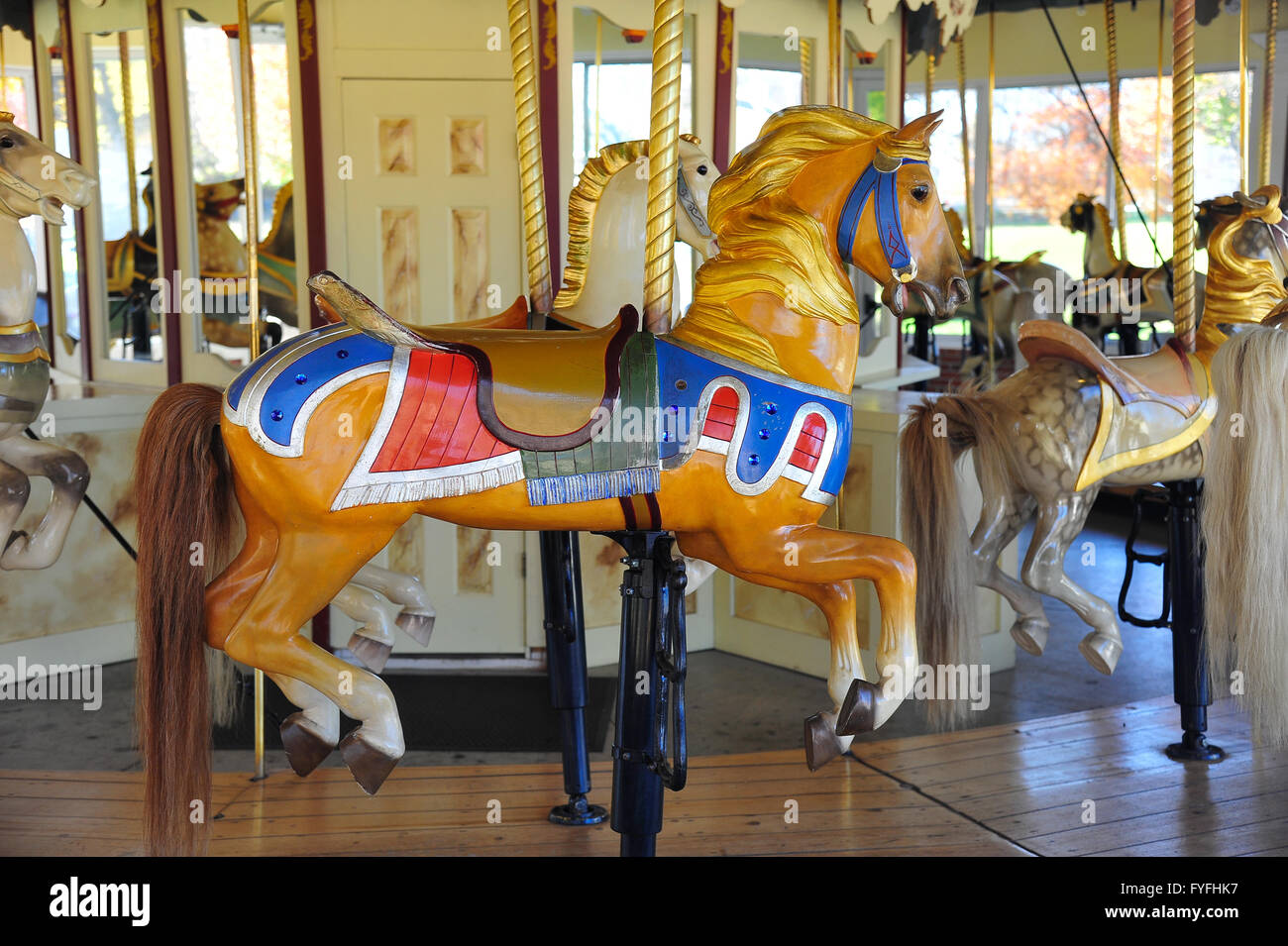 Children's roundabout, nostalgic carousel with wooden horses from 1910 ...