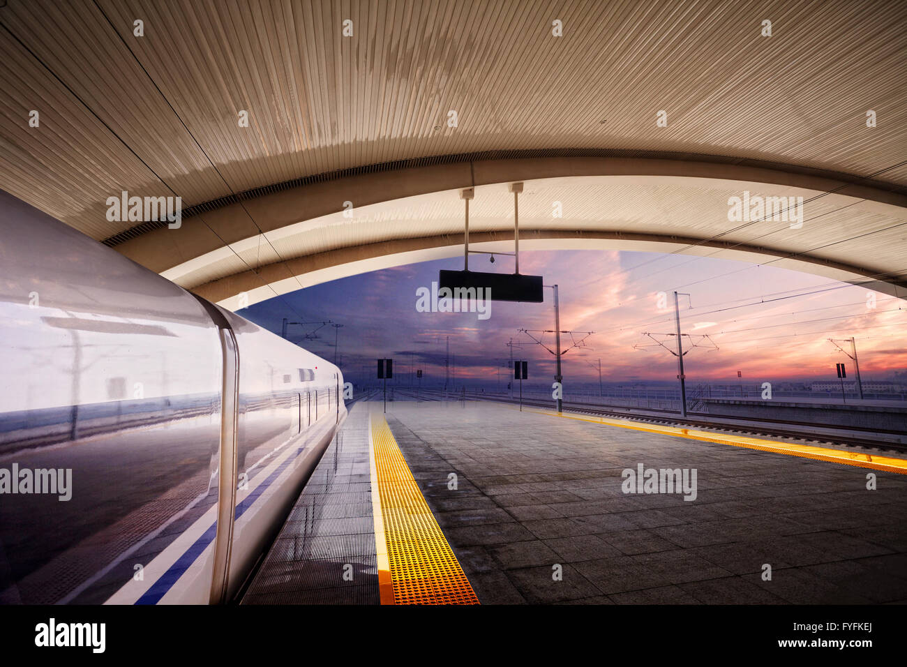 train stop at railway station with sunset Stock Photo - Alamy