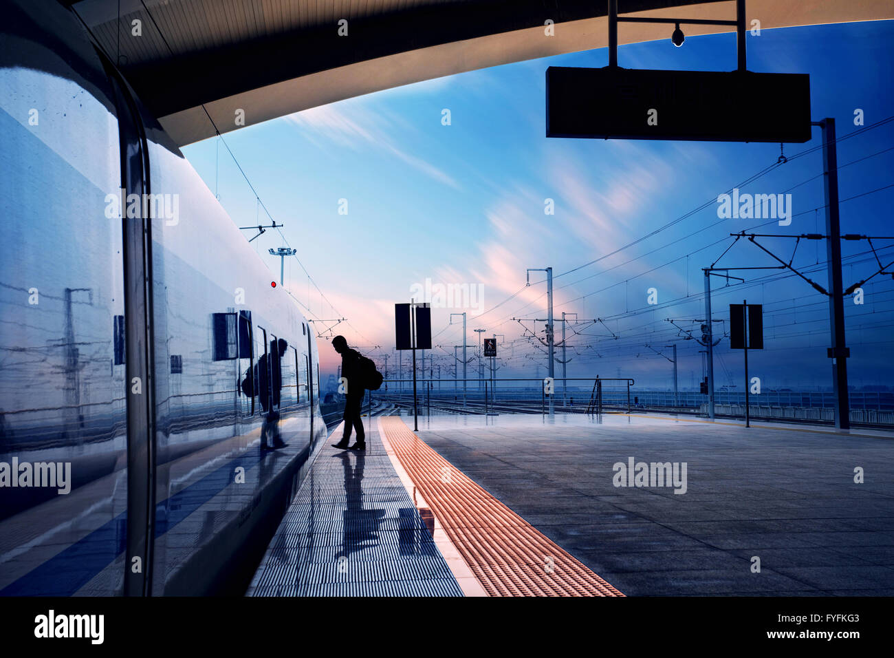 train stop at railway station with sunset Stock Photo - Alamy