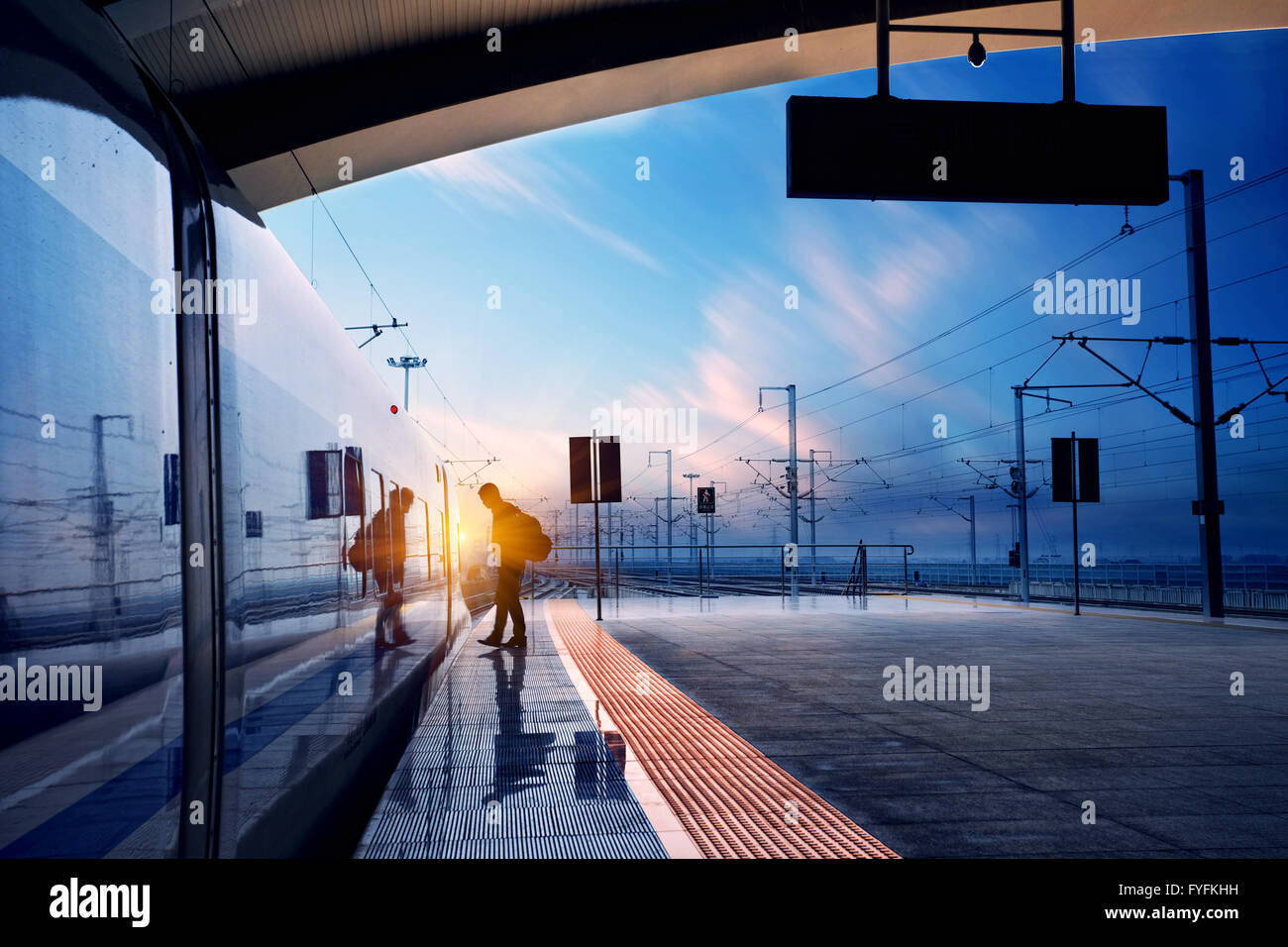 train stop at railway station with sunset Stock Photo - Alamy