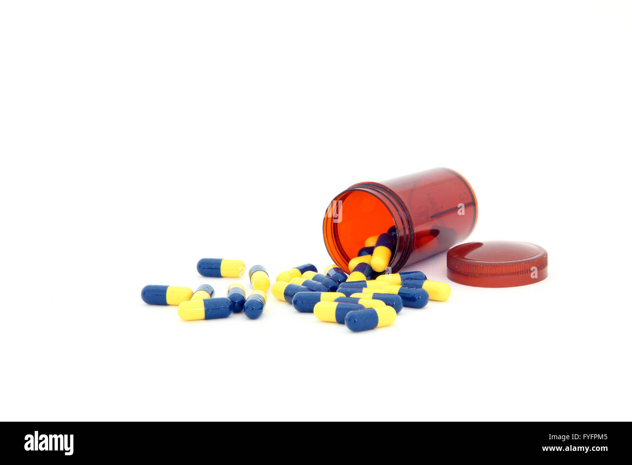 isolated capsules spilling out from small bottle Stock Photo - Alamy