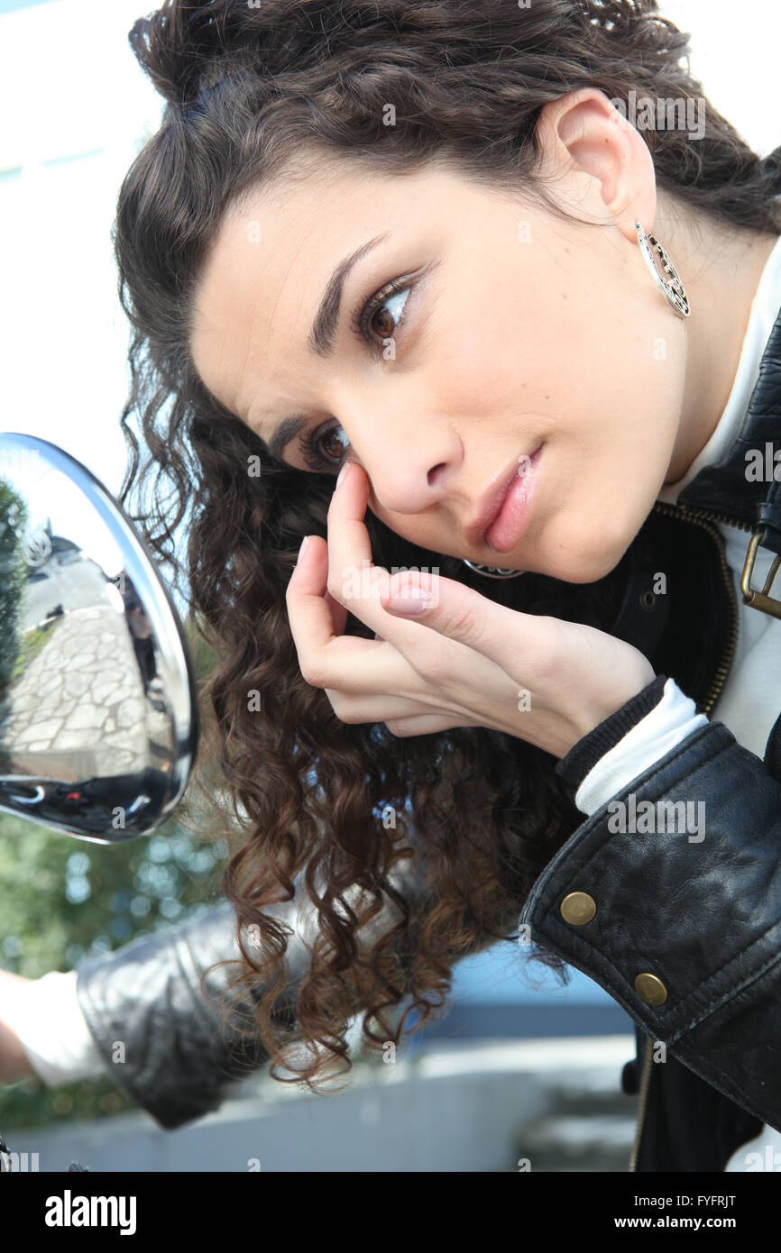 woman looking her eye in the rearview mirror Stock Photo - Alamy