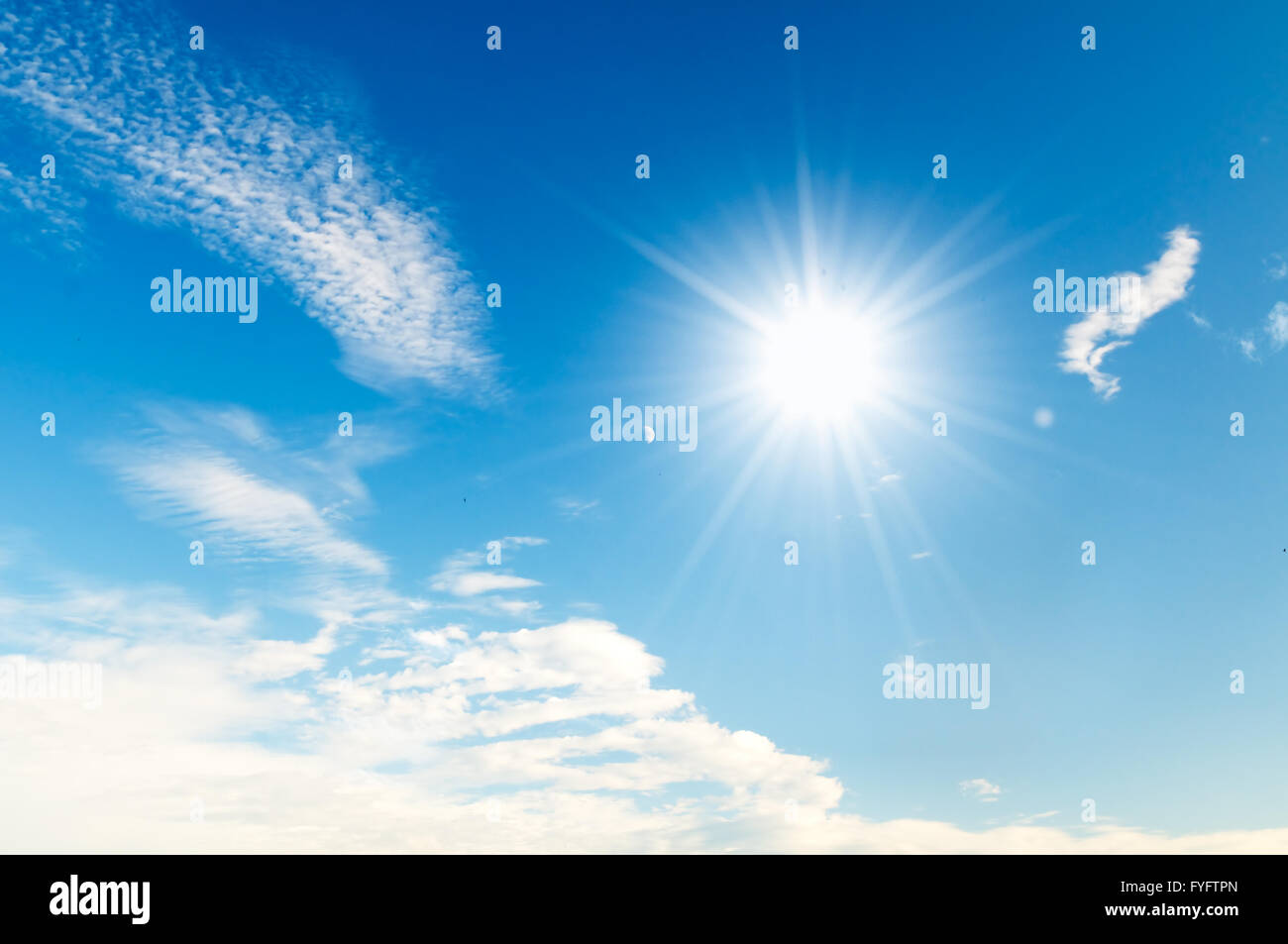 Sunny blue sky with fluffy clouds Stock Photo - Alamy