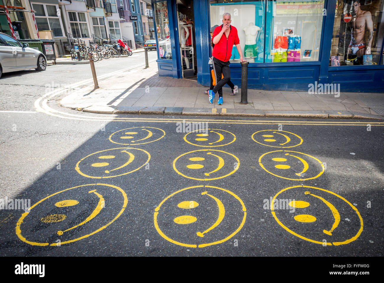 Smiley faces painted onto the road in Brighton Stock Photo - Alamy