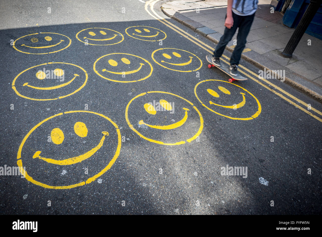 Smiley faces painted onto the road in Brighton Stock Photo - Alamy