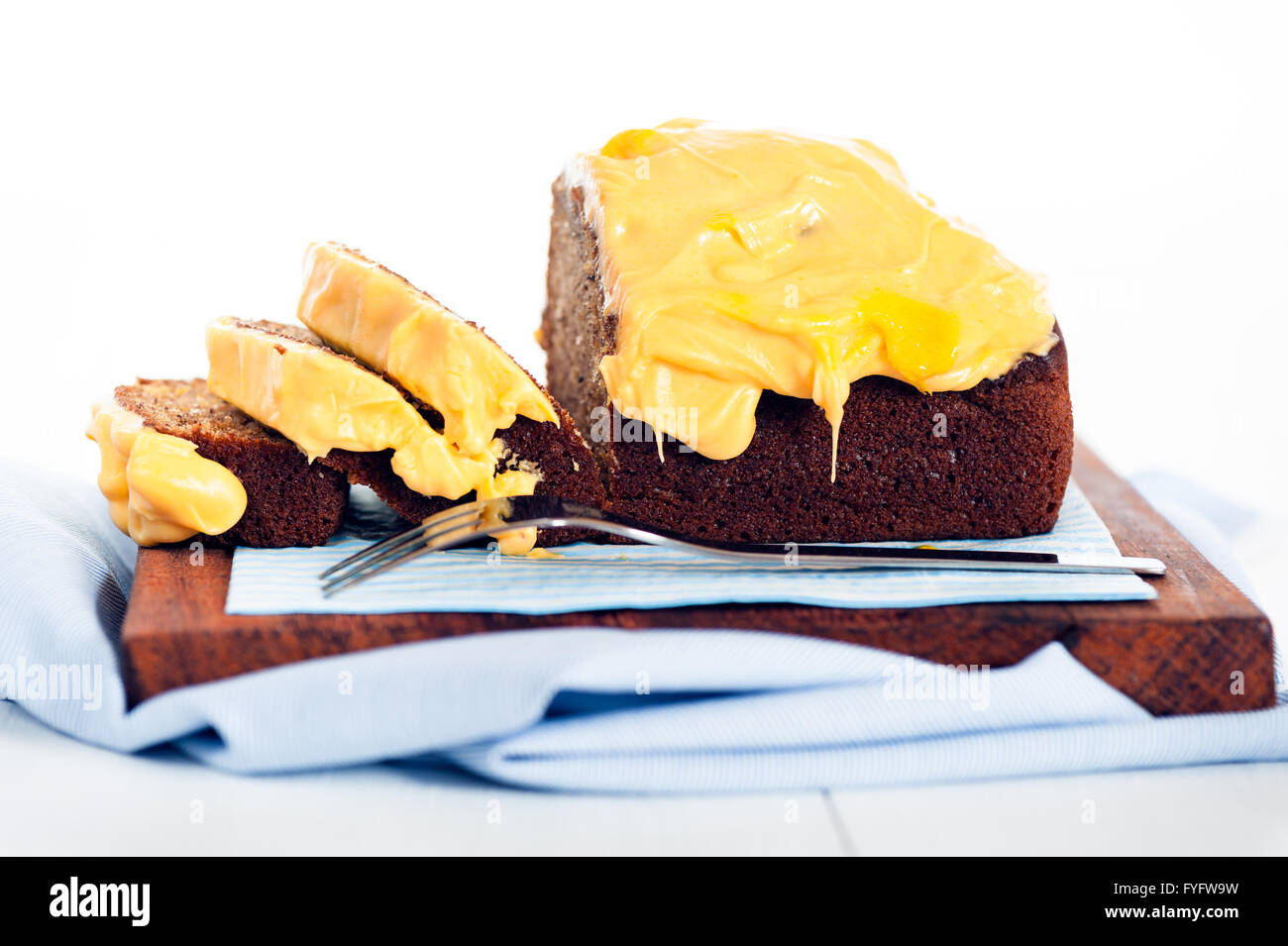 Cake with yellow icing Stock Photo - Alamy