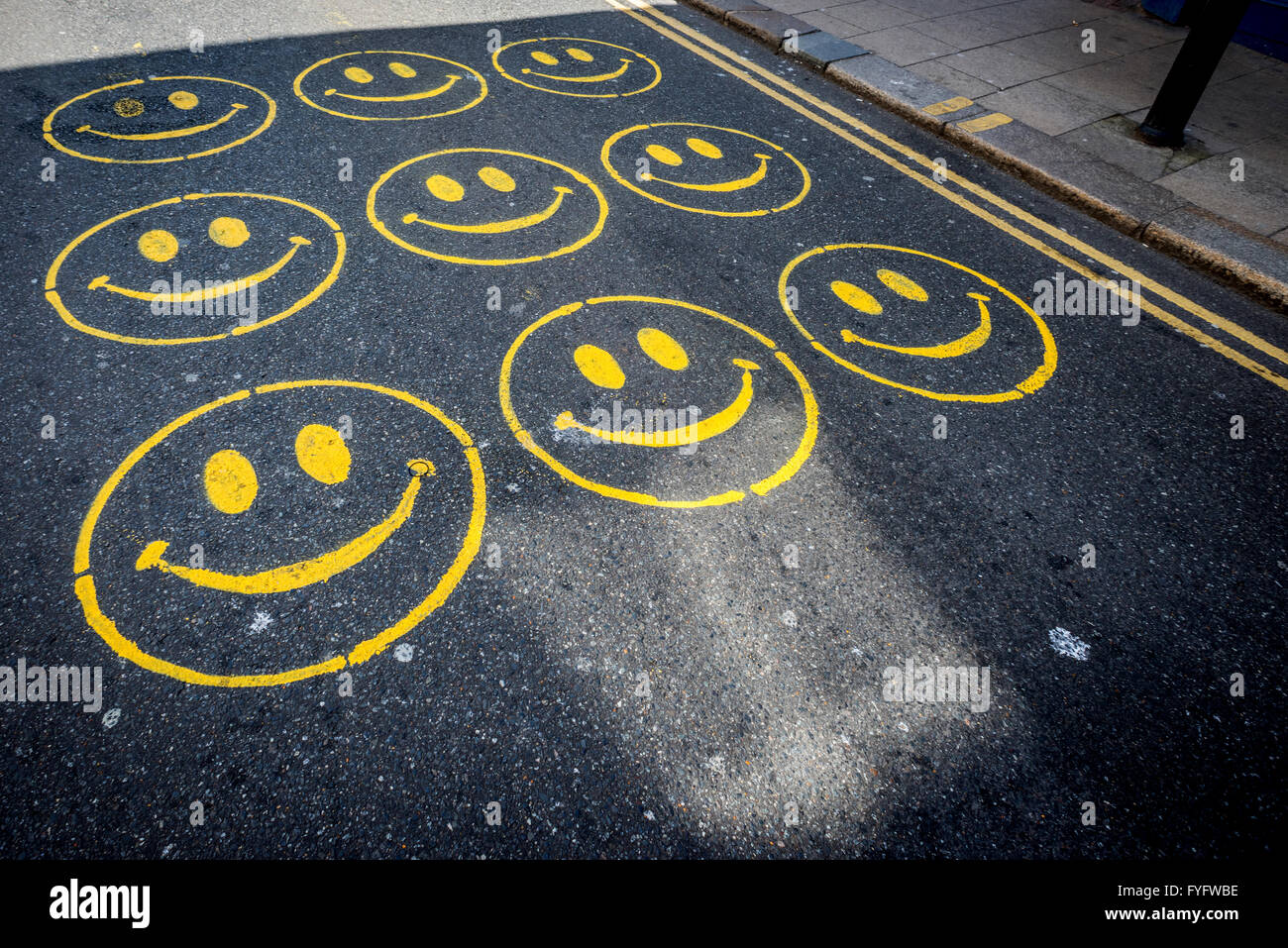 Smiley faces painted onto the road in Brighton Stock Photo - Alamy