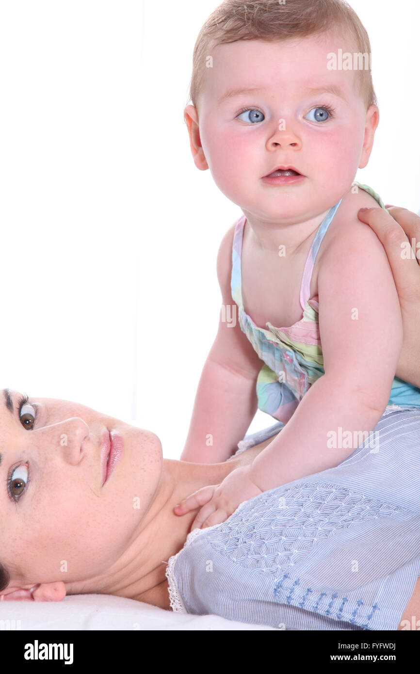 Mother playing with her baby girl on her chest Stock Photo - Alamy
