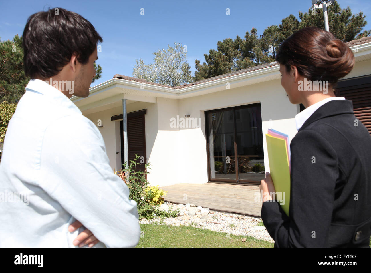 Estate agent about to show customer around property Stock Photo - Alamy