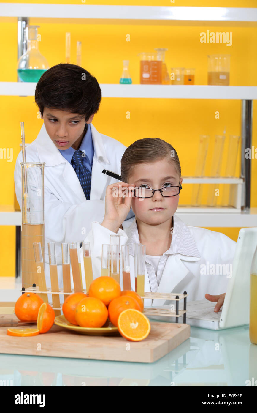 Children doing chemistry experiments with orange juice Stock Photo - Alamy