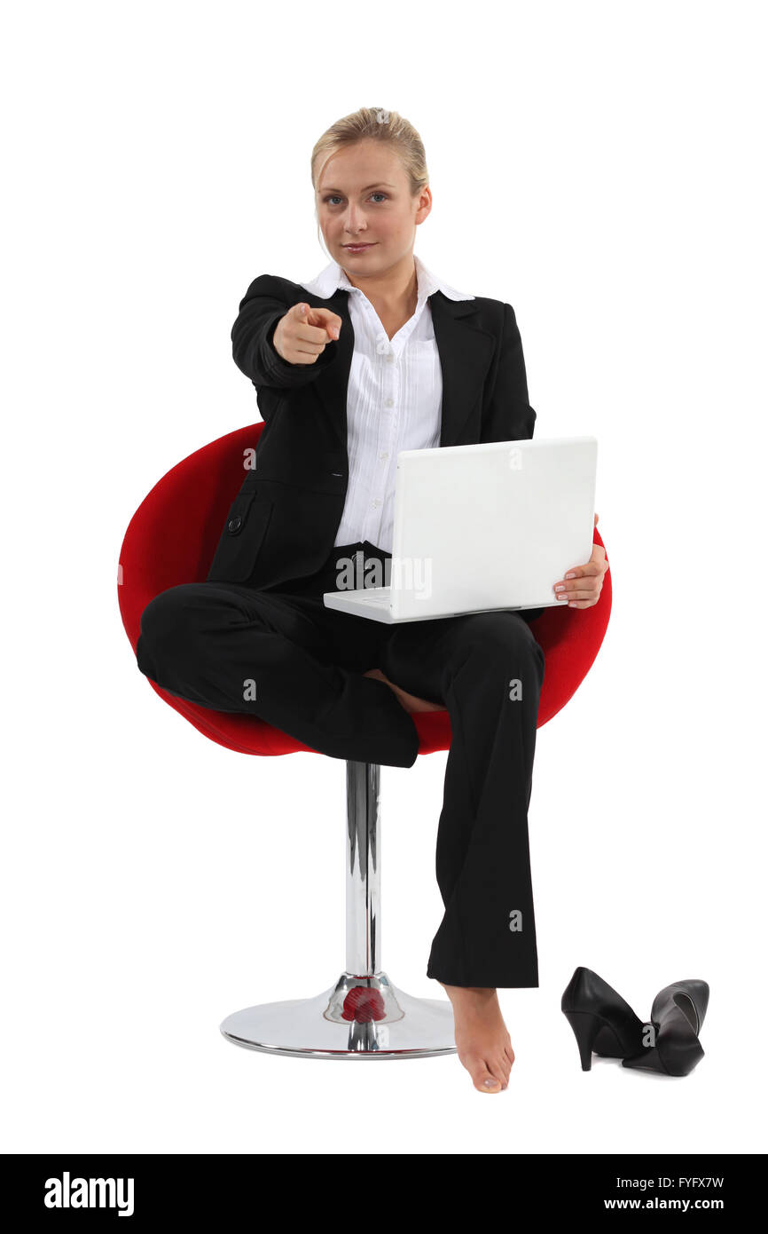 Businesswoman sitting in a chair and pointing her index finger Stock ...