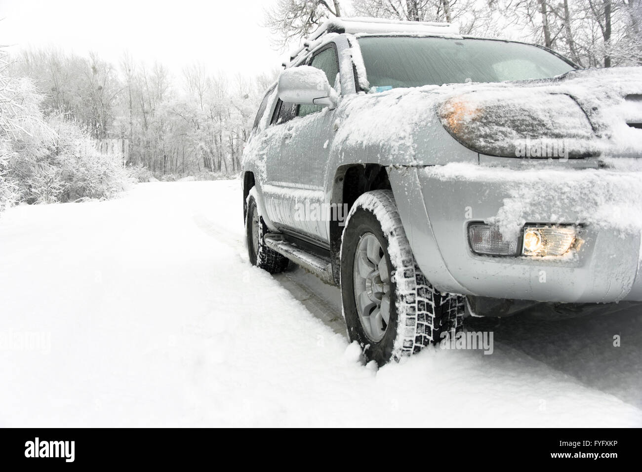 Snowy winter road behind an unrecognizable car Stock Photo - Alamy
