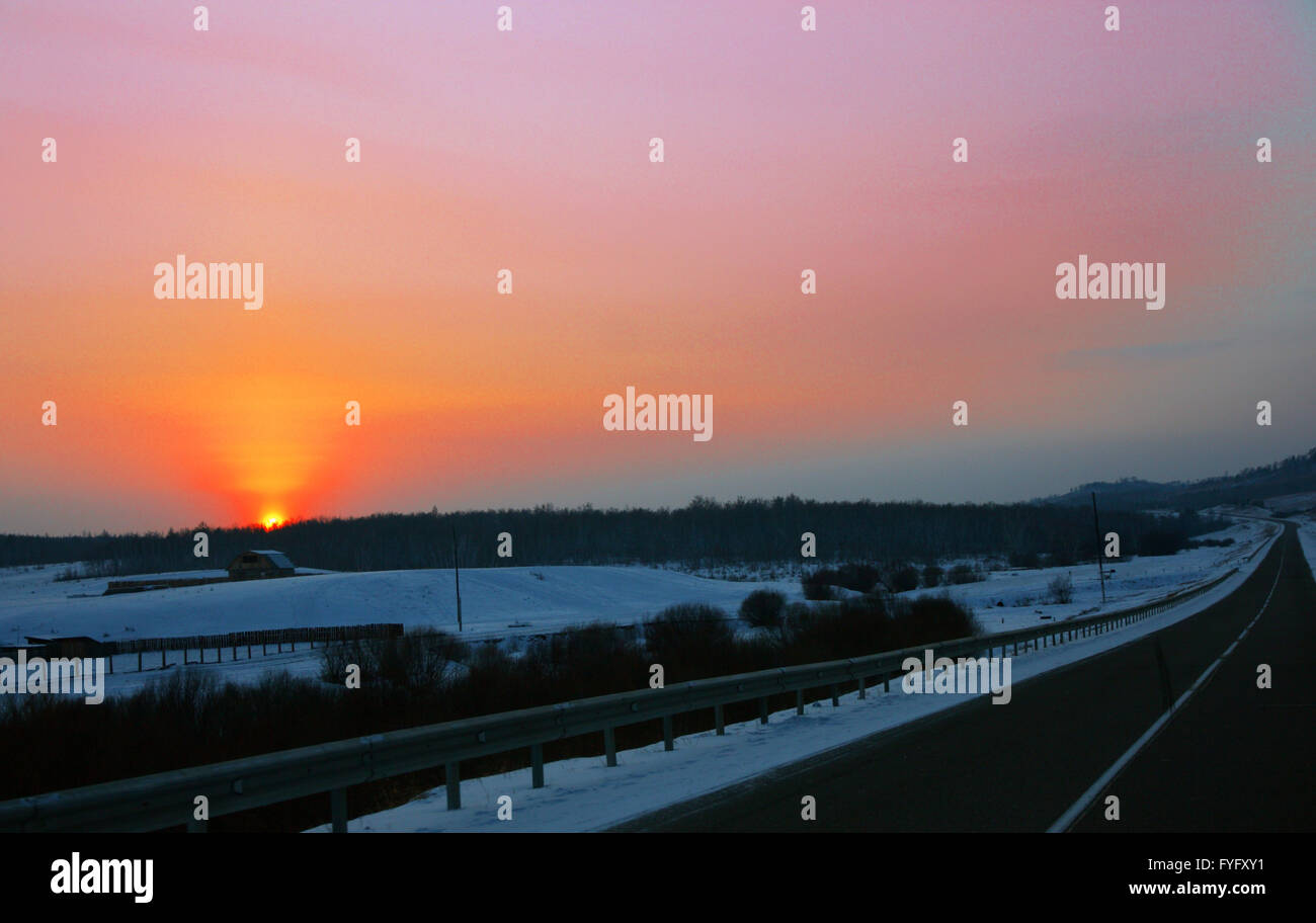house in front of a winter sunset in snow Stock Photo - Alamy