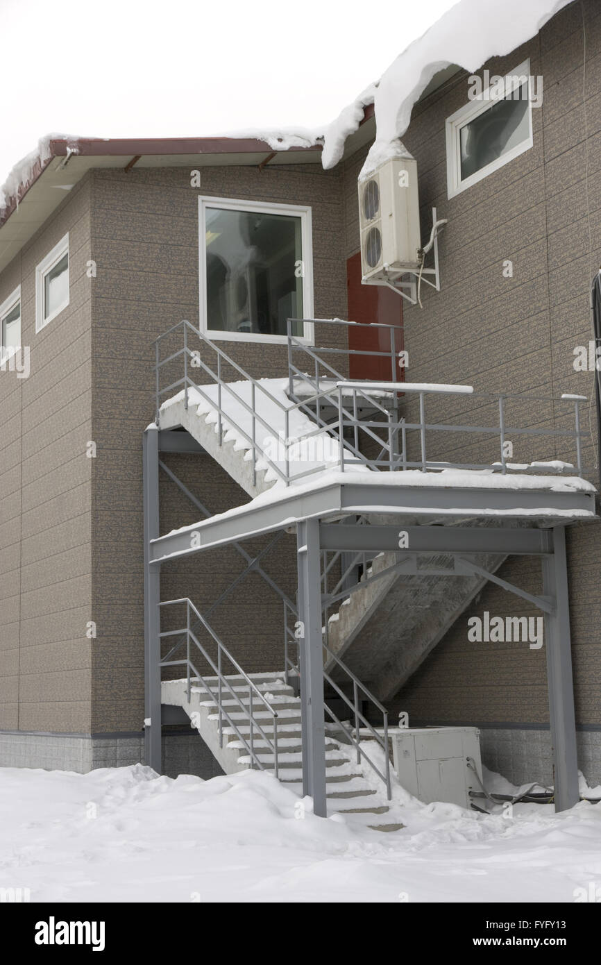 Ladder in snow on the second floor with windows Stock Photo - Alamy