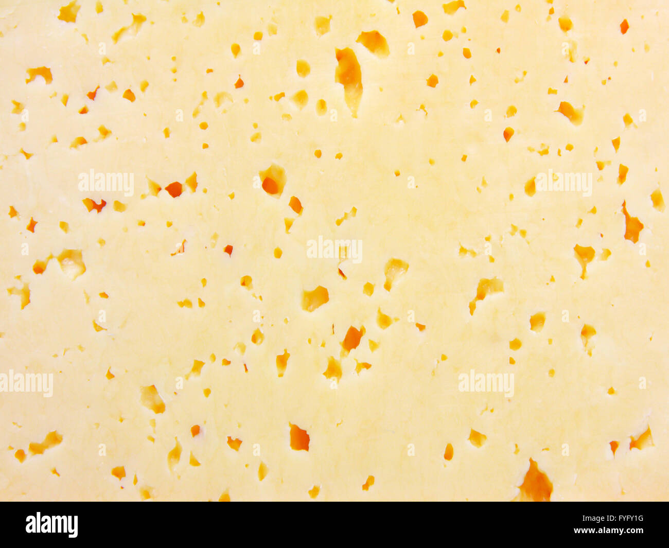 Background of fresh yellow Swiss cheese with holes Stock Photo - Alamy