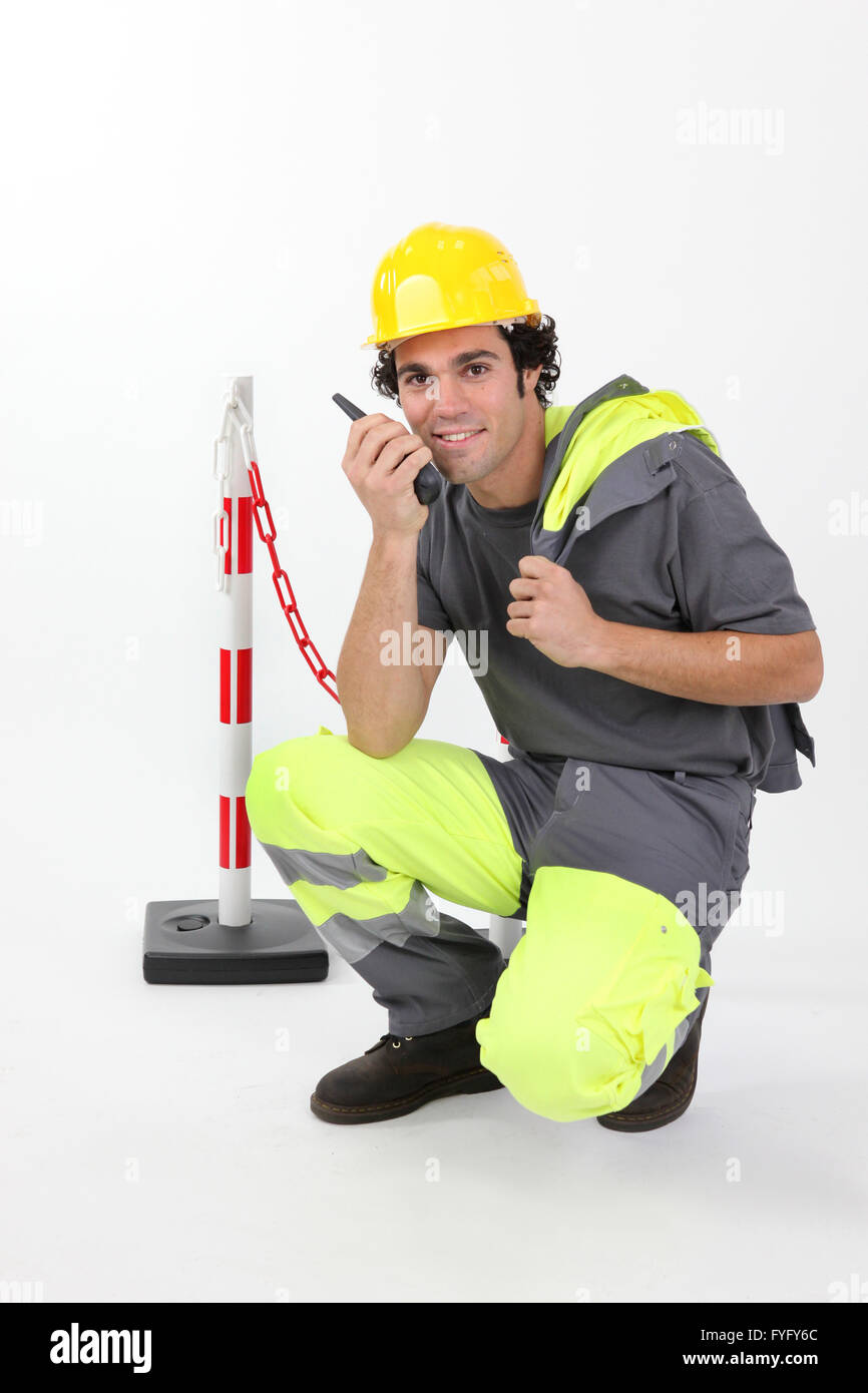 Worker in reflective work-wear using radio receiver Stock Photo - Alamy