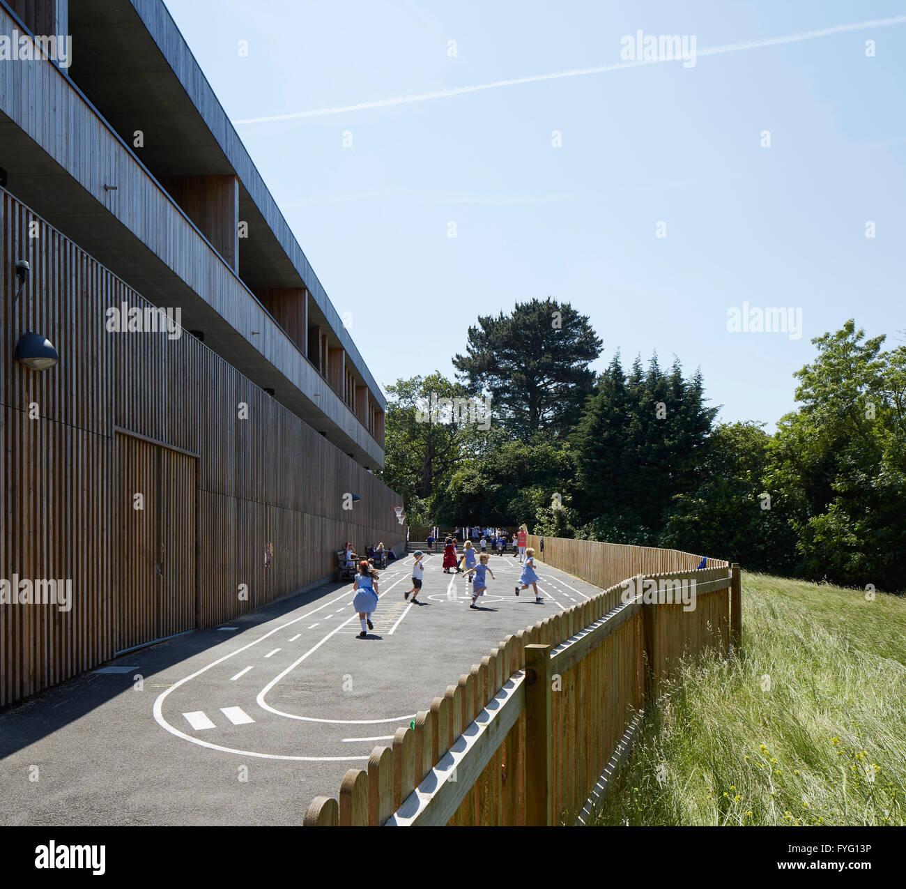 Timber clad facade perspective with fenced in play area. Branfil School ...