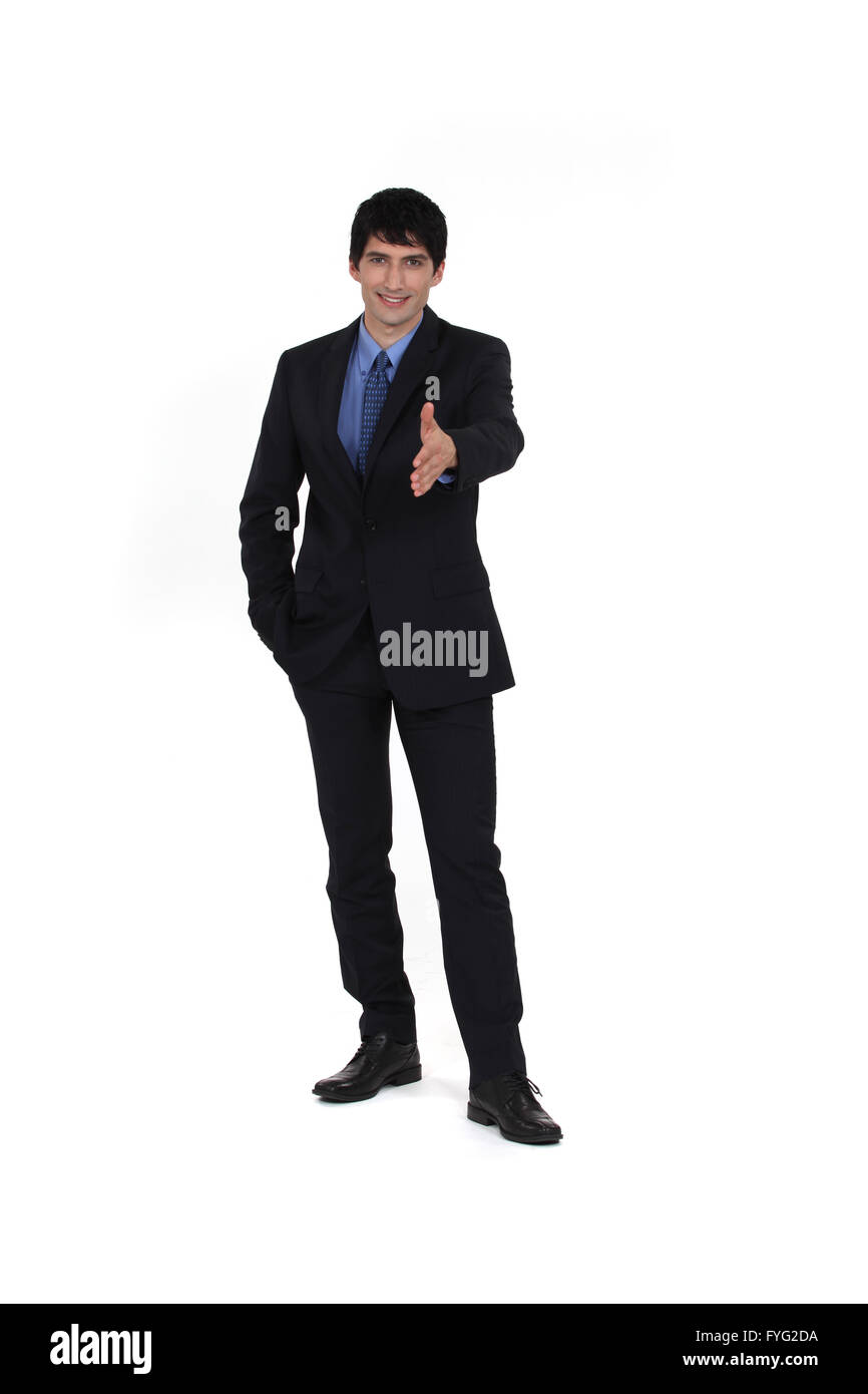 Businessman holding his hand out for a handshake Stock Photo - Alamy