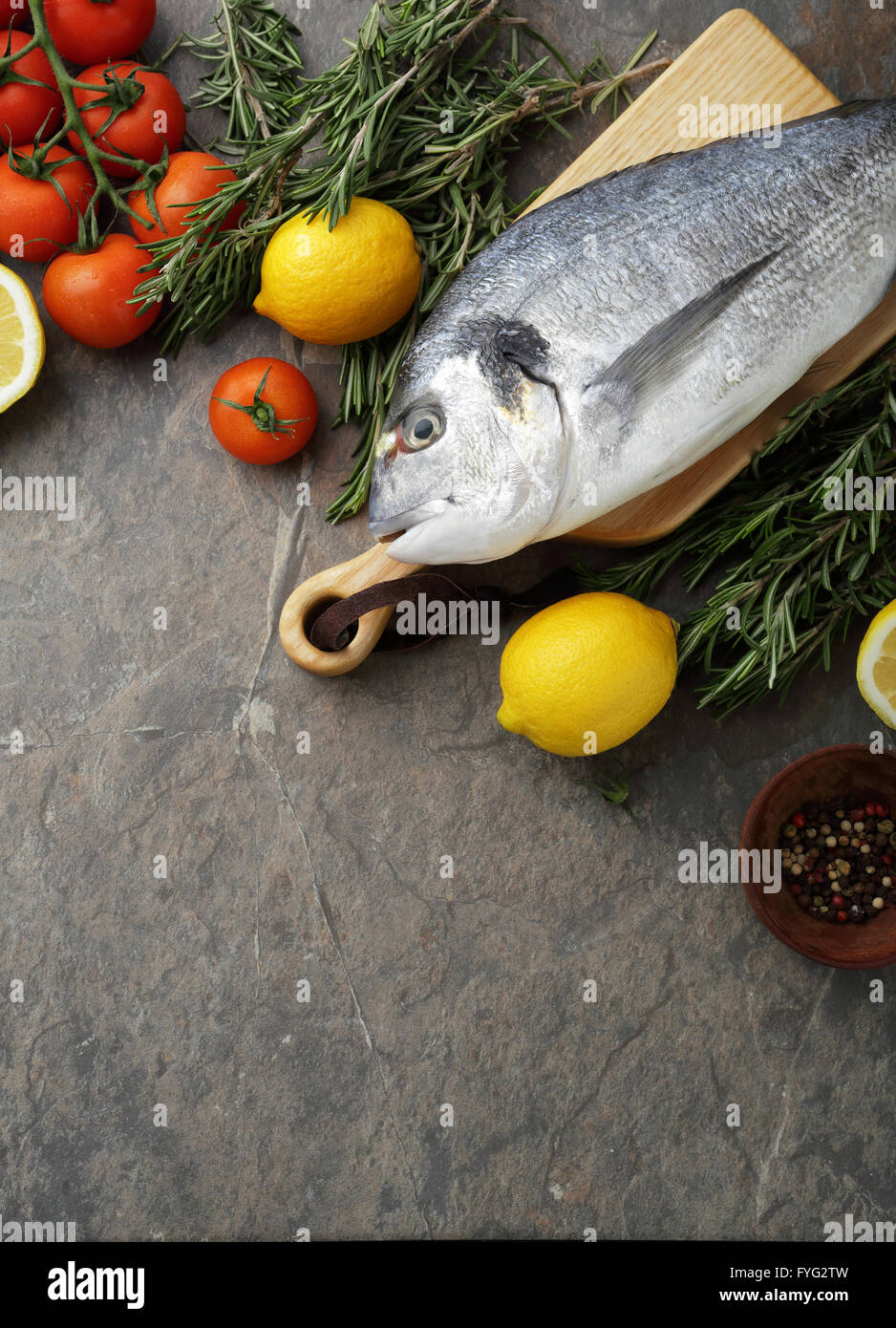 food background with raw fish and herbs Stock Photo - Alamy