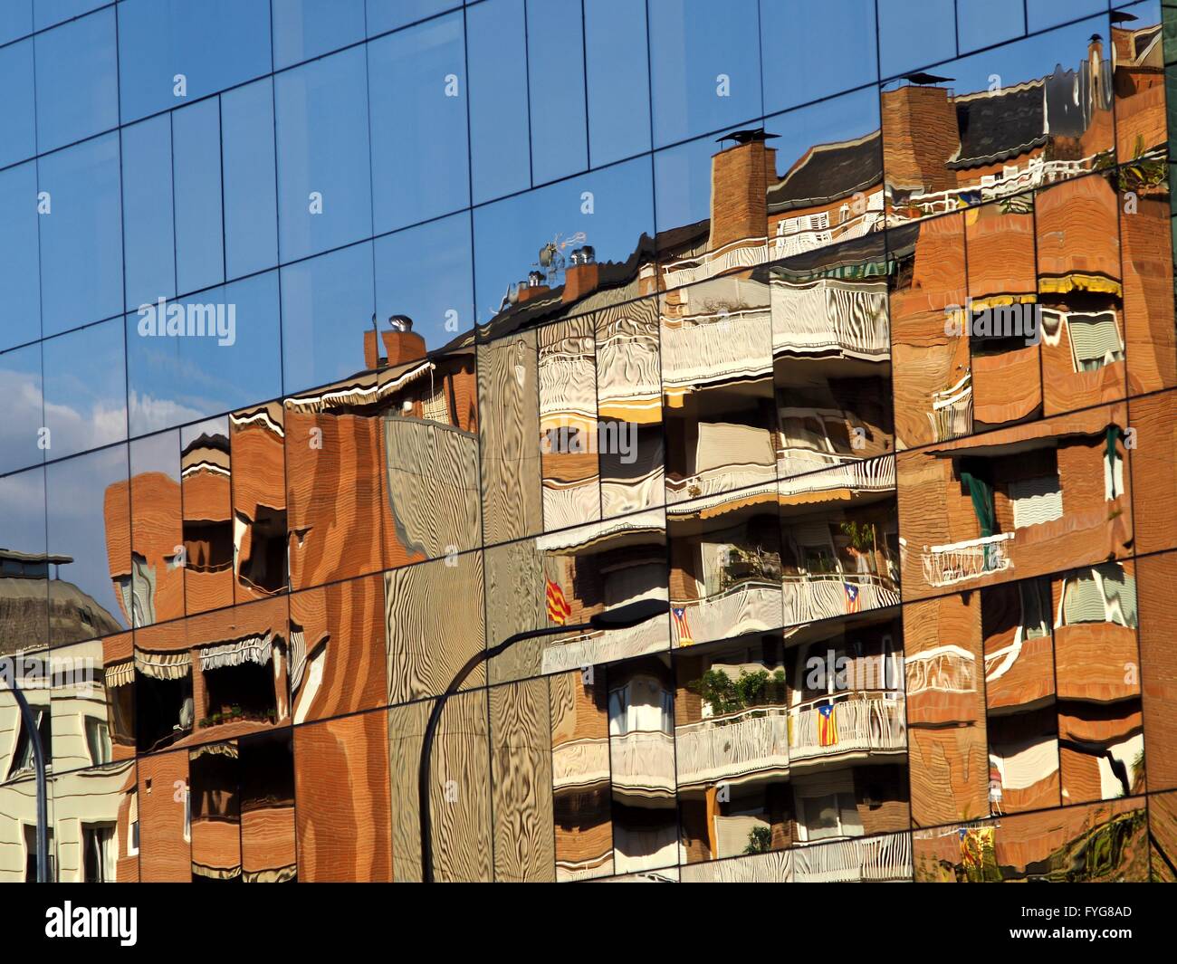 Reflection of apartment building in Barcelona in glass-fronted office ...