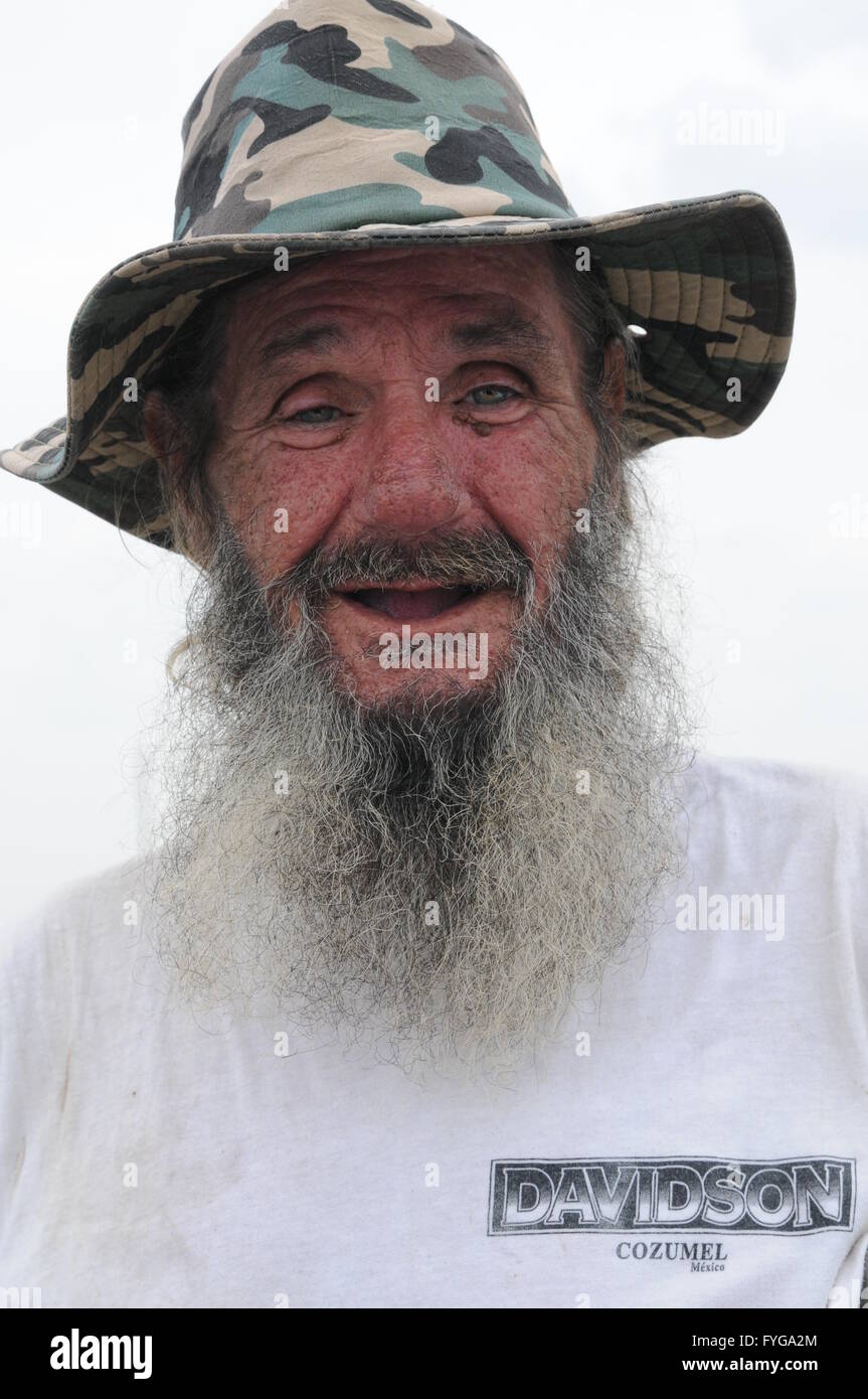 Bearded homeless man smiles for his portrait on the streets of Austin ...